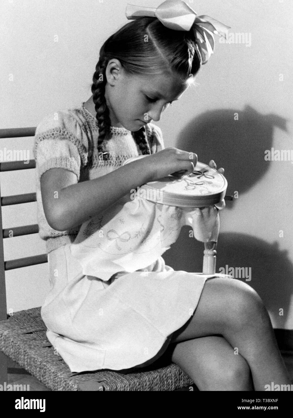little girl embroidering, 1949 Stock Photo - Alamy