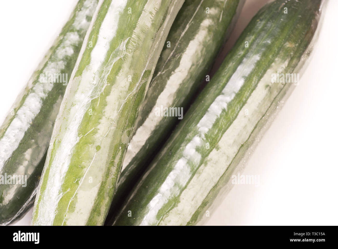 Bunch of cucumber wrapped in plastic films, isolated on white ...