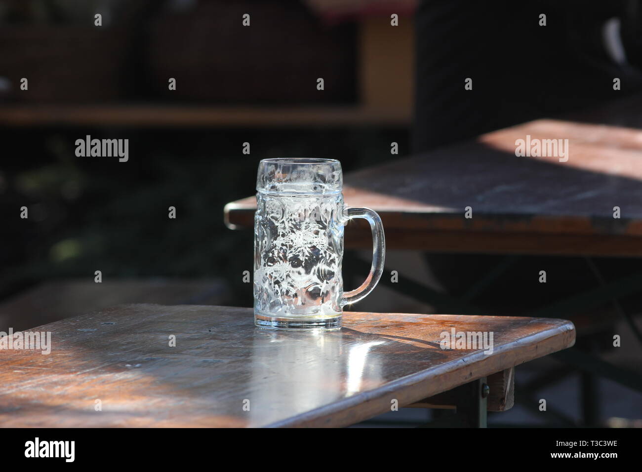 Abandoned empty beer mug on beer garden table Stock Photo - Alamy