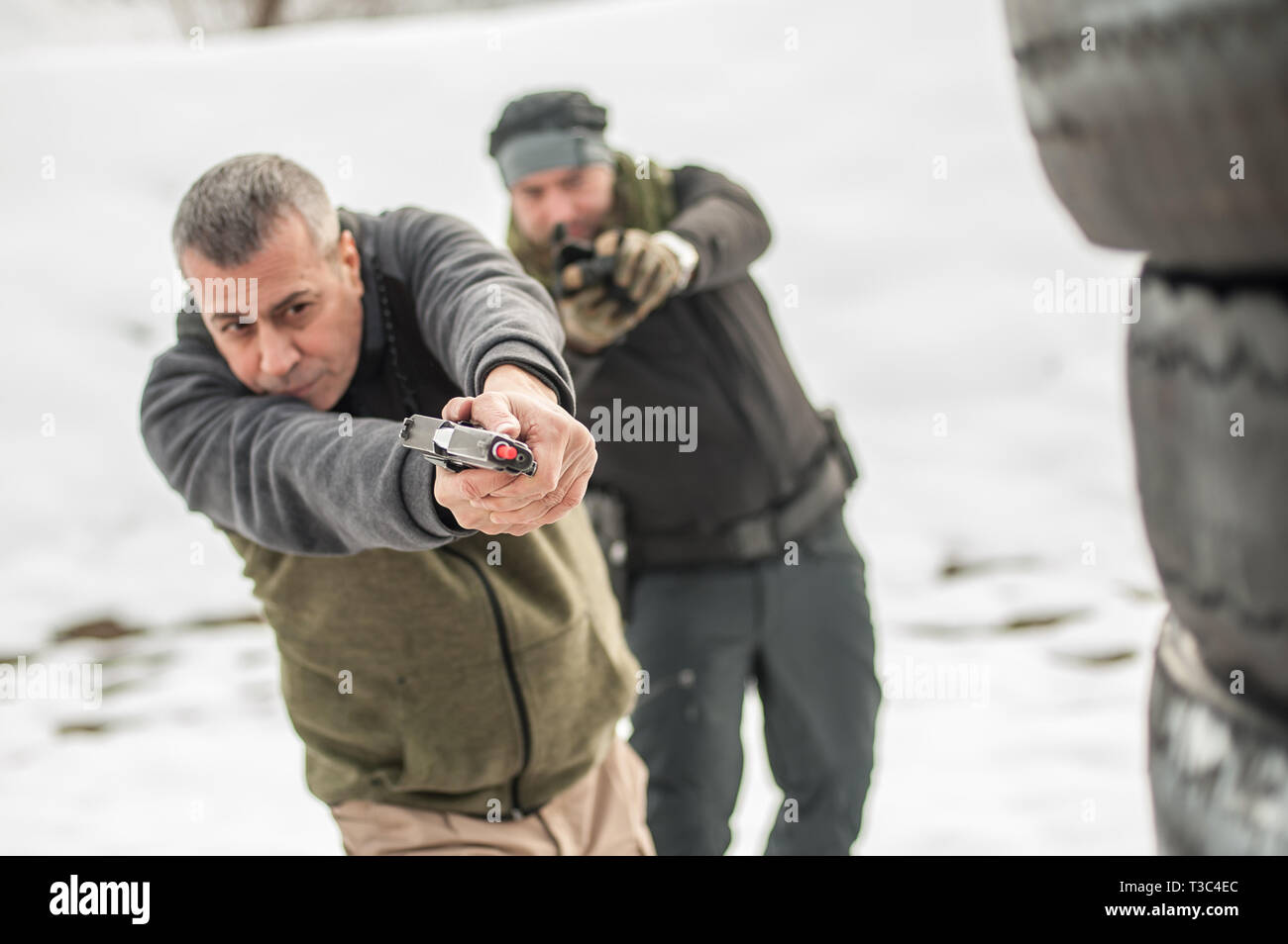 Instructor on shooting range teaches his student tactical gun shooting ...