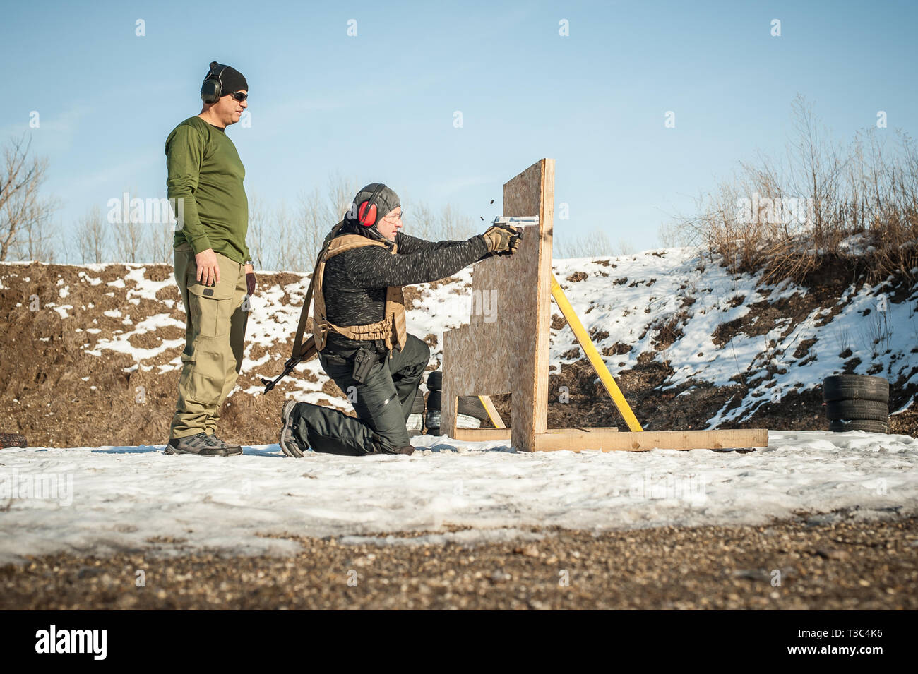 Instructor on shooting range teaches his student tactical gun shooting ...