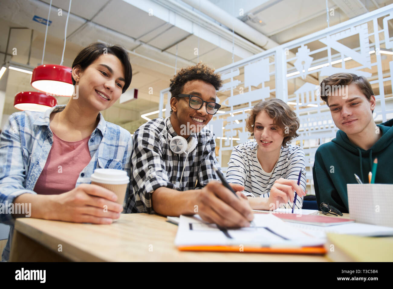 Excited students working on project Stock Photo - Alamy