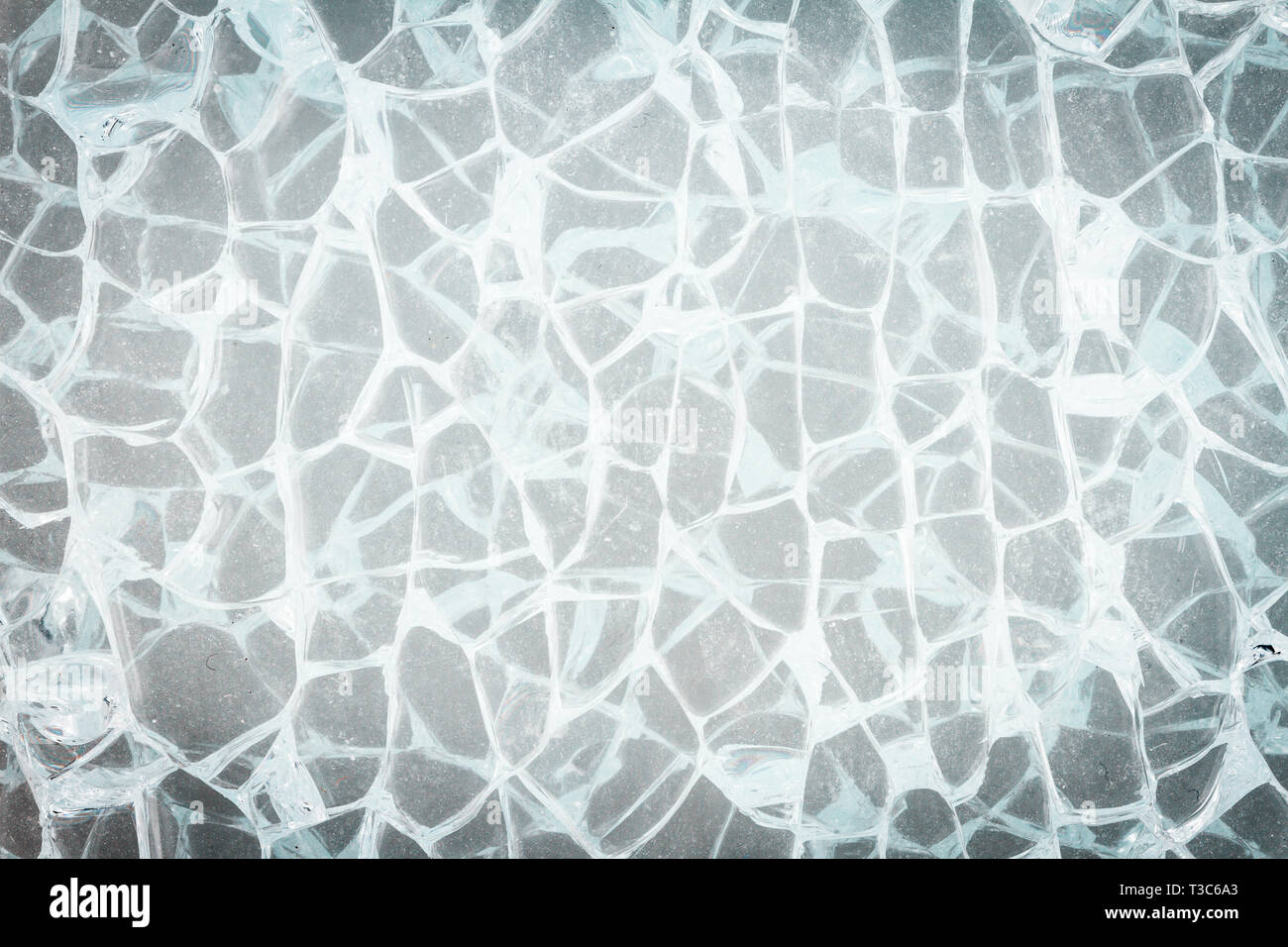Broken windshield glass texture on a gray background. Broken glass with ...
