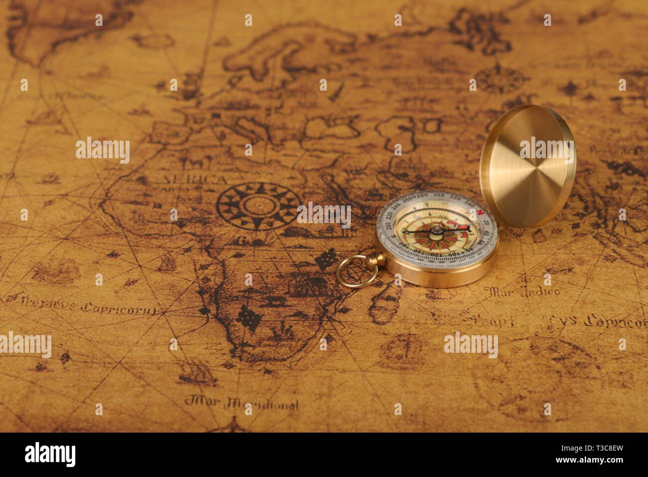 Old compass on ancient map hi-res stock photography and images - Alamy
