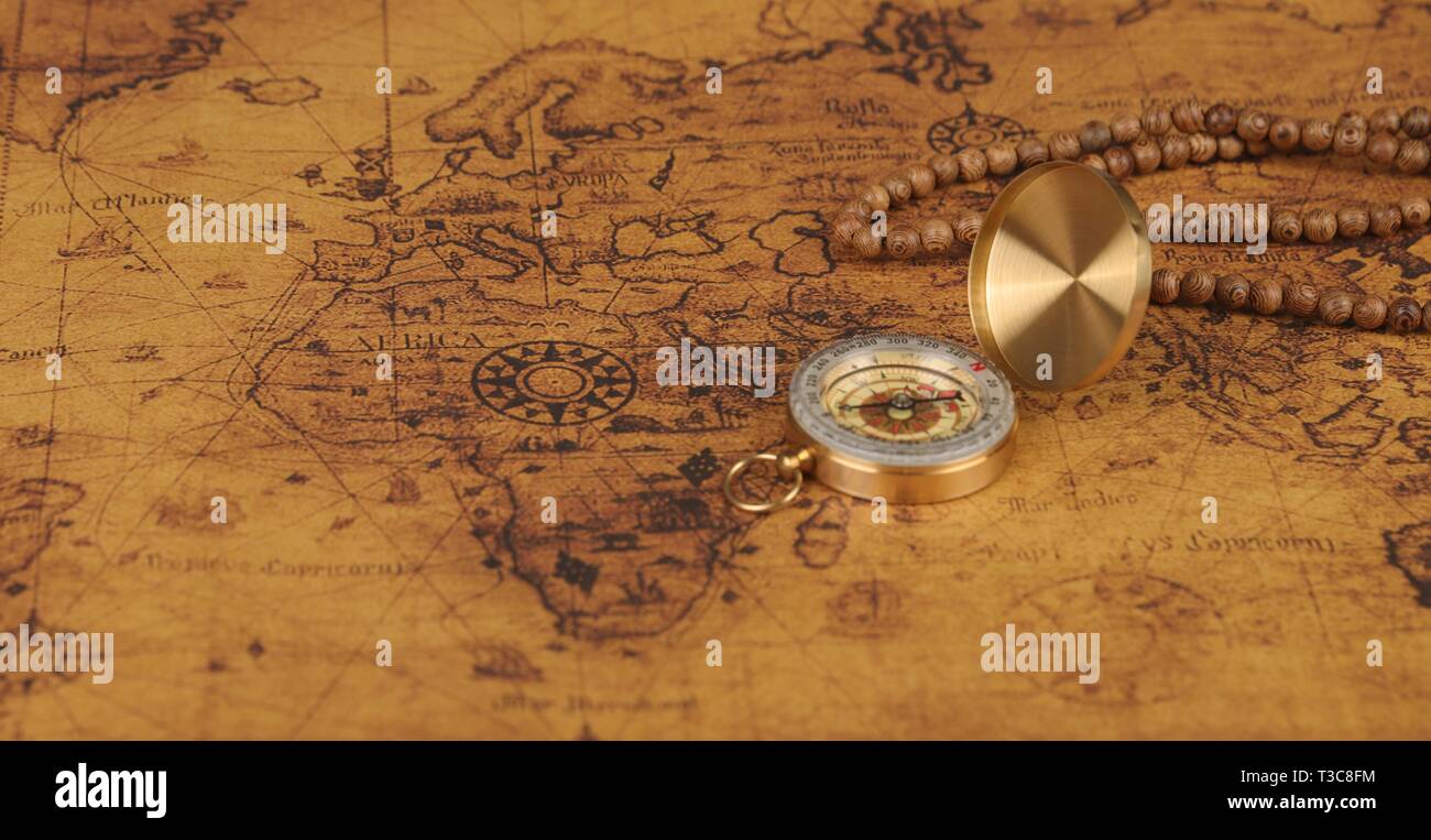 Vintage Compass lies on an ancient world map - adventure stories ...