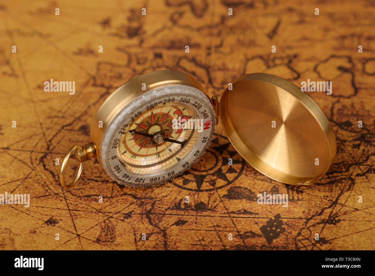 Vintage Compass lies on an ancient world map - adventure stories ...