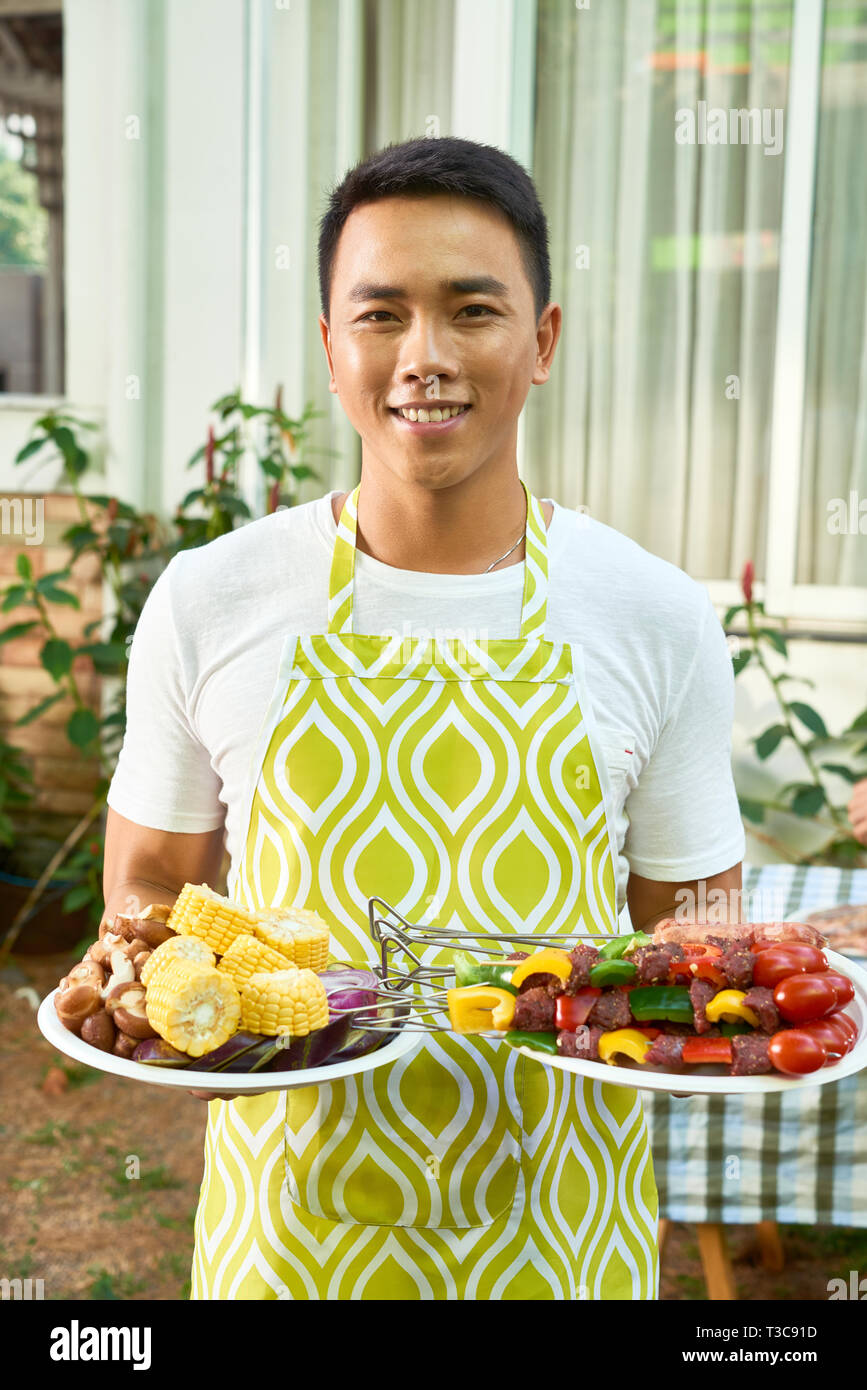 Happy man cooking barbecue Stock Photo - Alamy