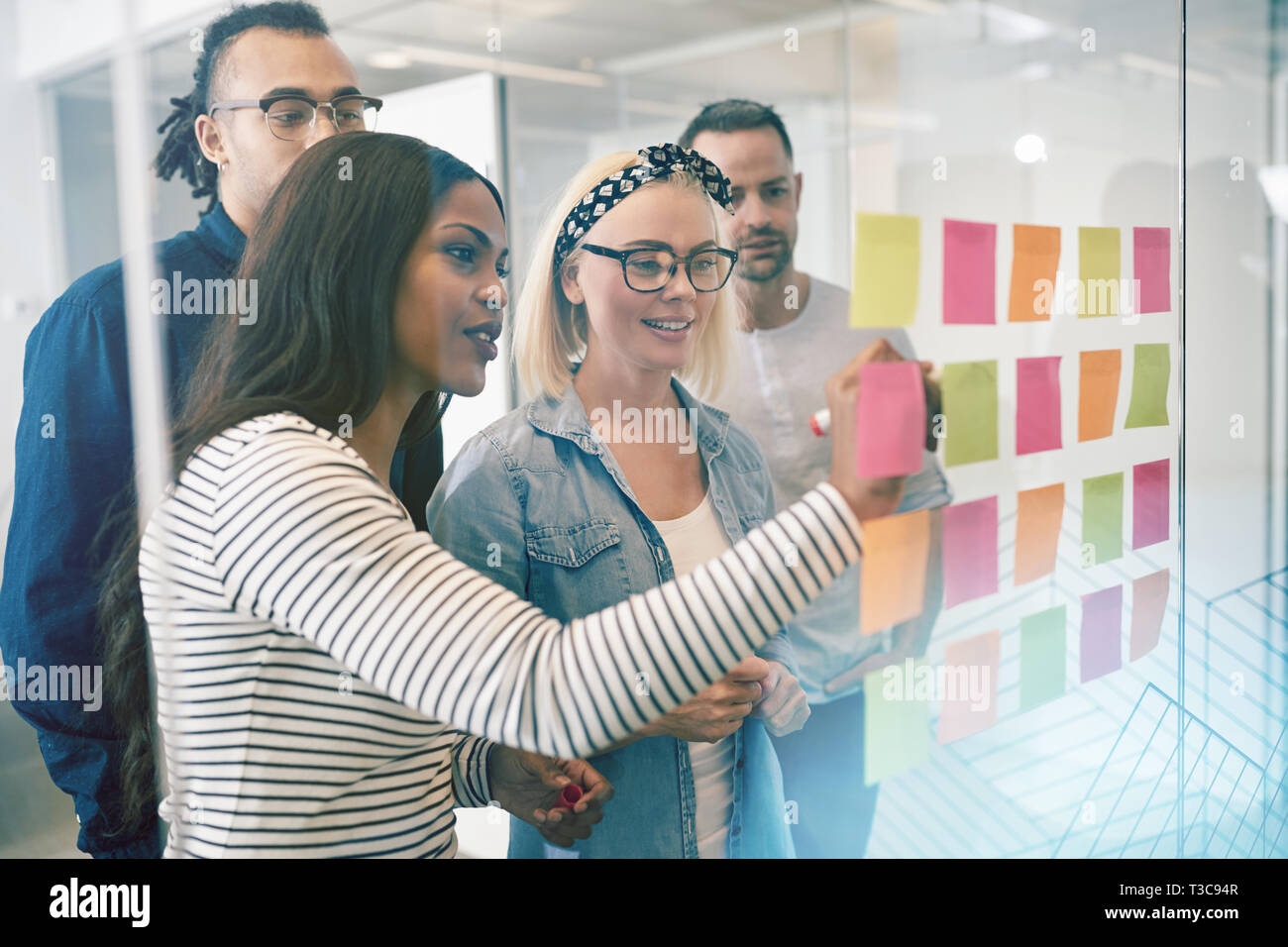 Smiling group of diverse business professionals brainstorming together ...