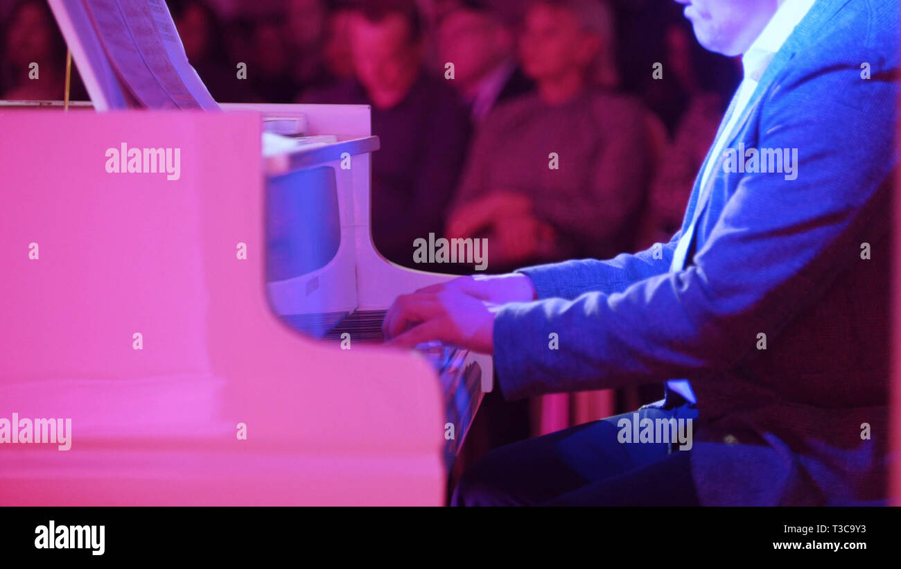 A man playing piano at the concert Stock Photo - Alamy
