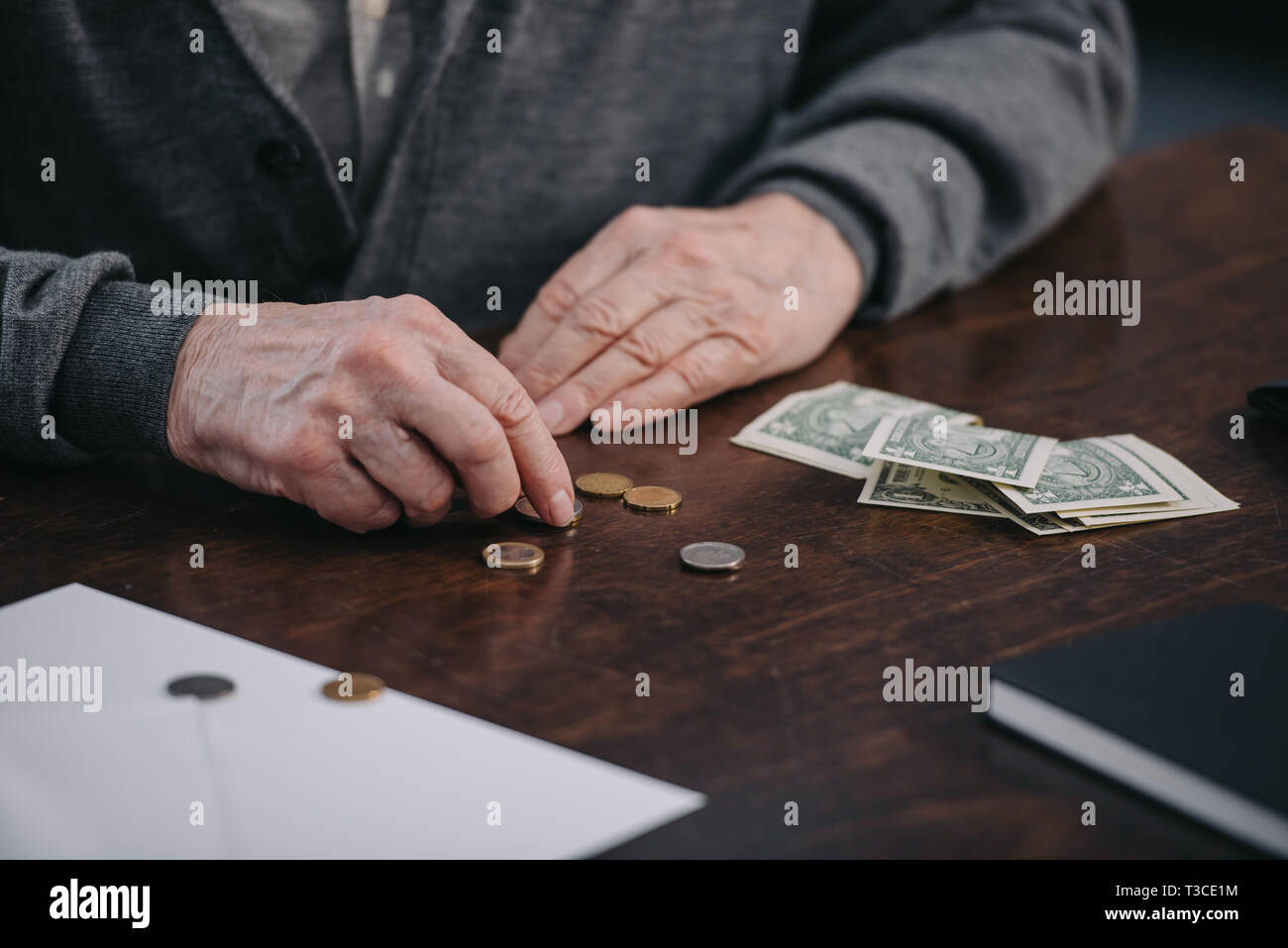 Senior man counting coins hi-res stock photography and images - Alamy