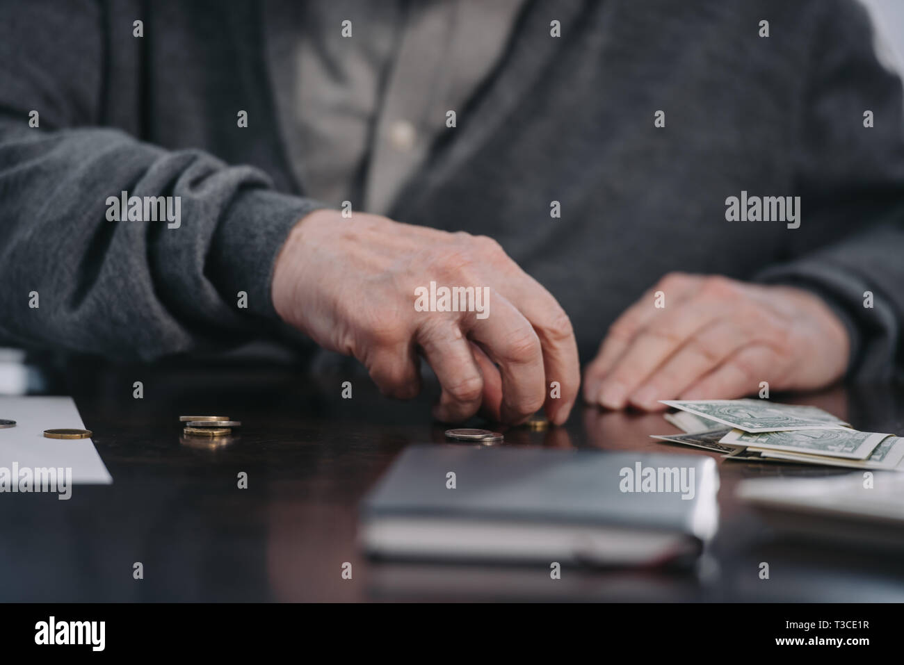 Senior man counting coins hi-res stock photography and images - Alamy