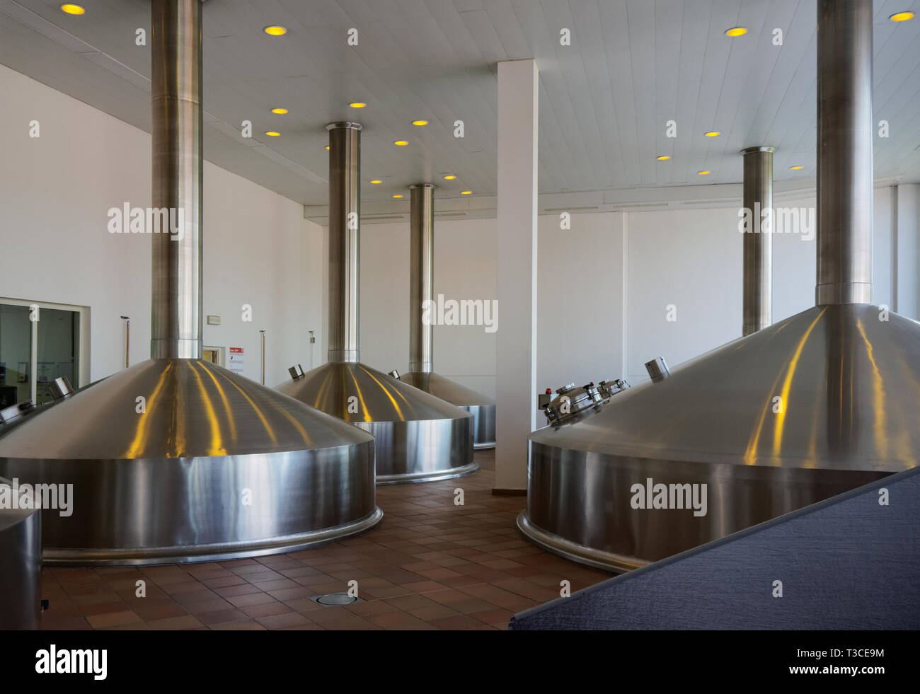 Beer-brewing tanks in industrial building Stock Photo - Alamy