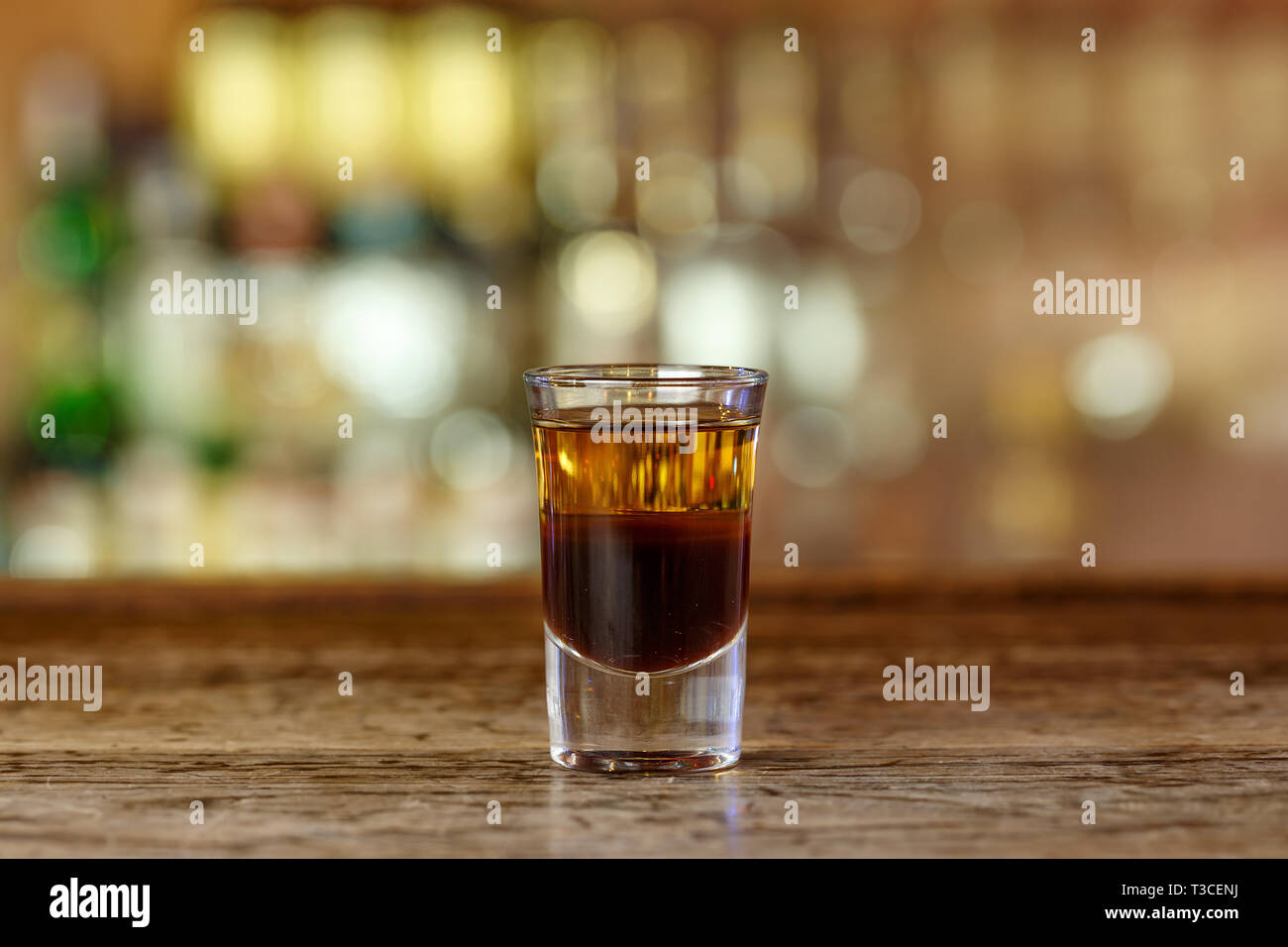 Cocktail shot with whiskey on the bar, space for text Stock Photo - Alamy