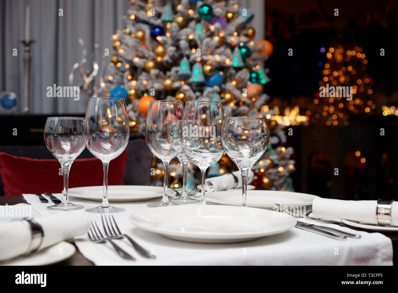 Place setting with Christmas tree in background, shallow focus depth ...