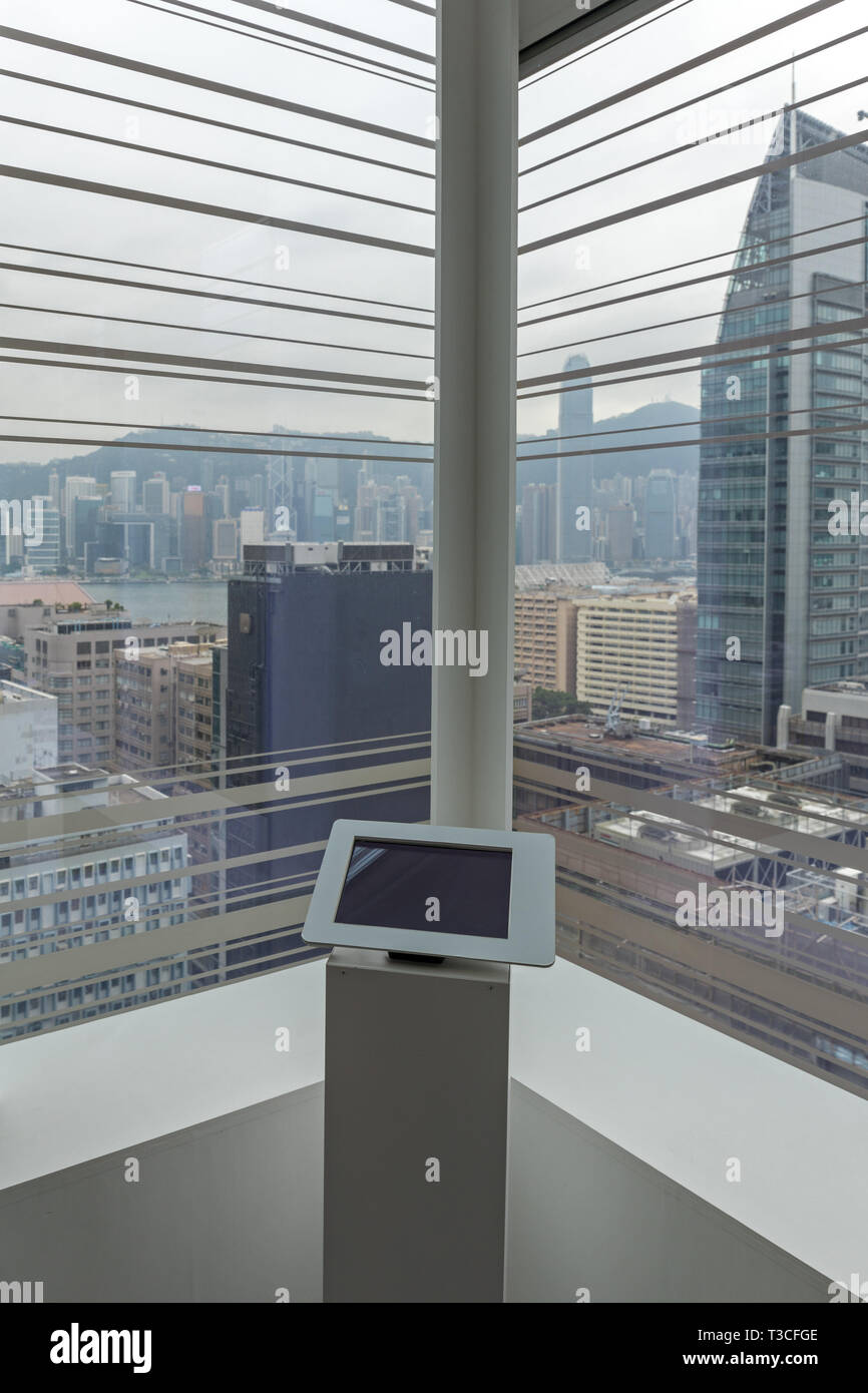 Tablet Display in Corner Window Skyscraper Hong Kong Stock Photo - Alamy