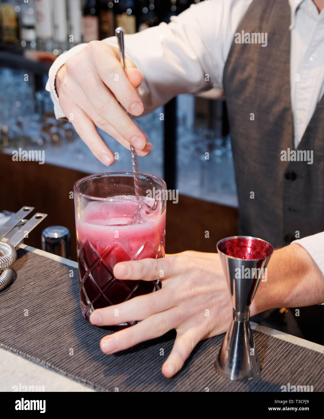 Bartender is stirring a shrub cocktail with sparkling wine Stock Photo ...