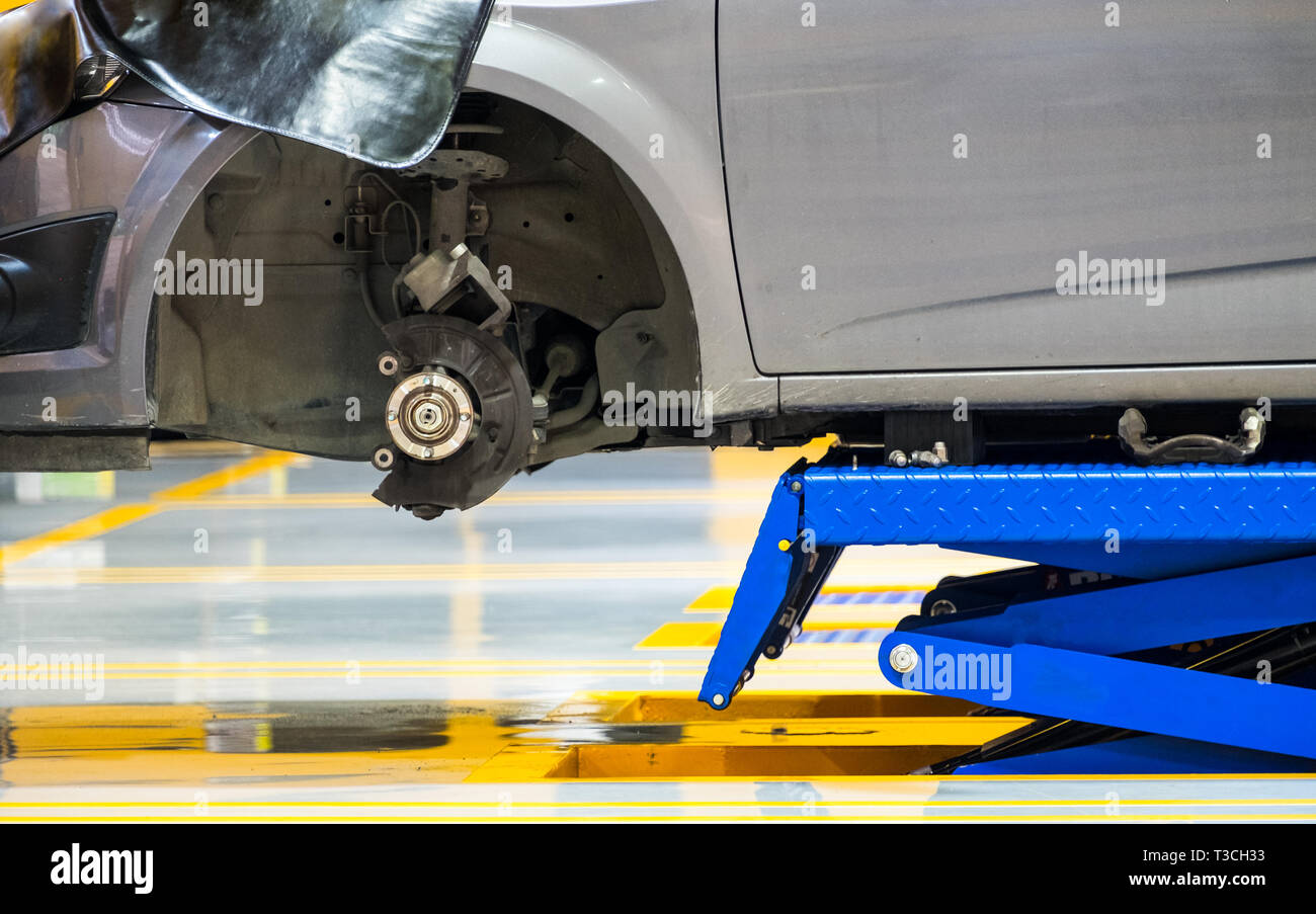 Car hub front lifting scissors blue in garage Stock Photo - Alamy