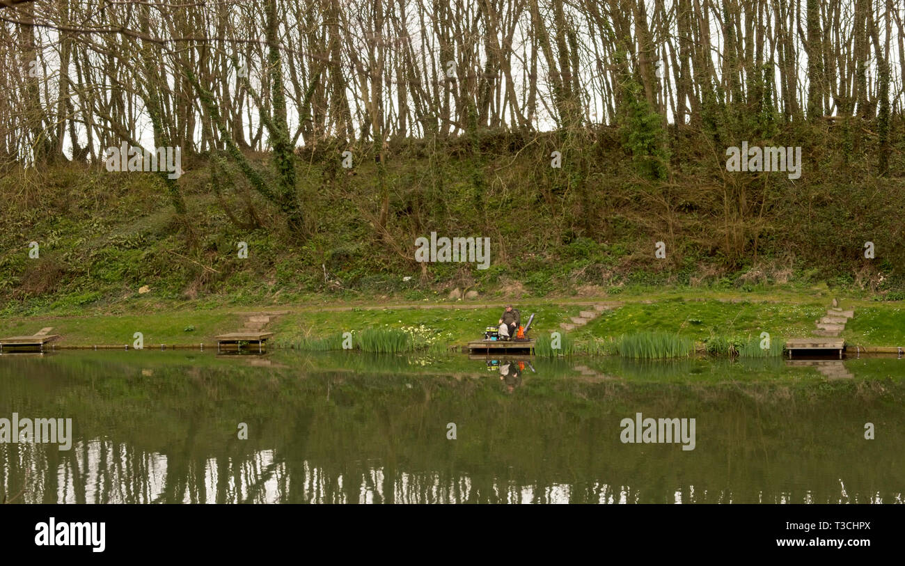 Freshwater angler on pond bank Stock Photo - Alamy