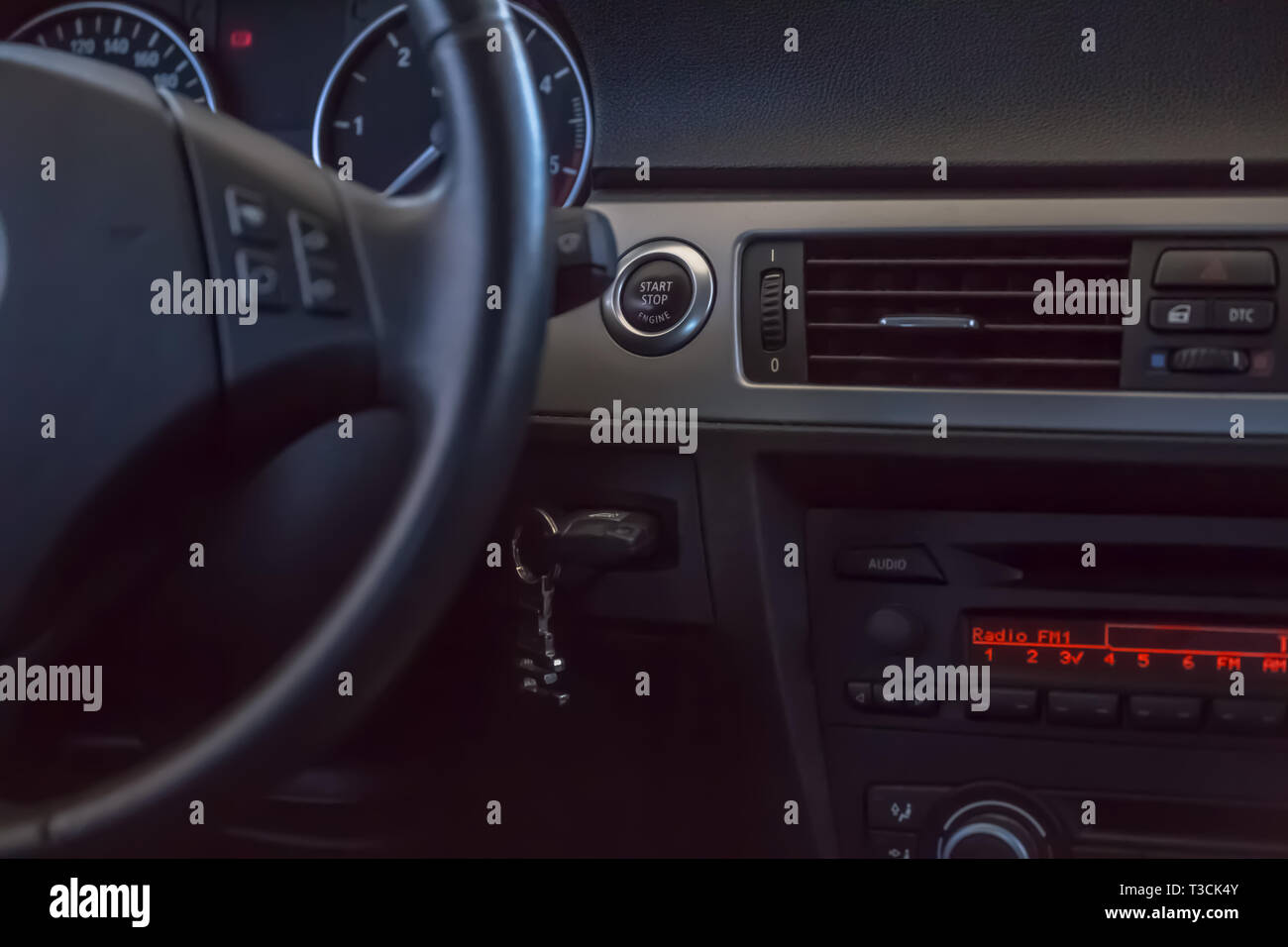 View of the interior of a modern car, steering wheel and radio panel ...