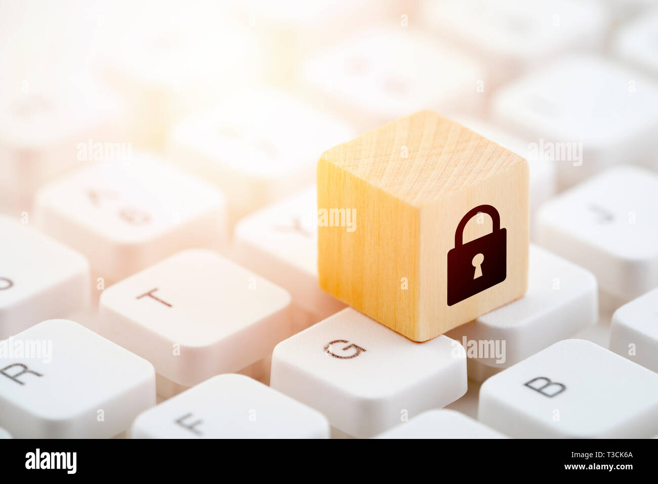 Wooden block with lock graphic on computer keyboard. Computer security ...