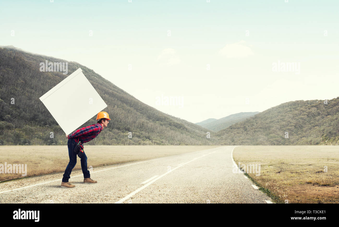 Man carrying on his back large box Stock Photo - Alamy