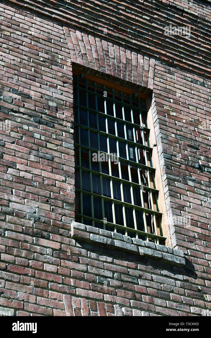 Brick building with steel bars in windows Stock Photo - Alamy