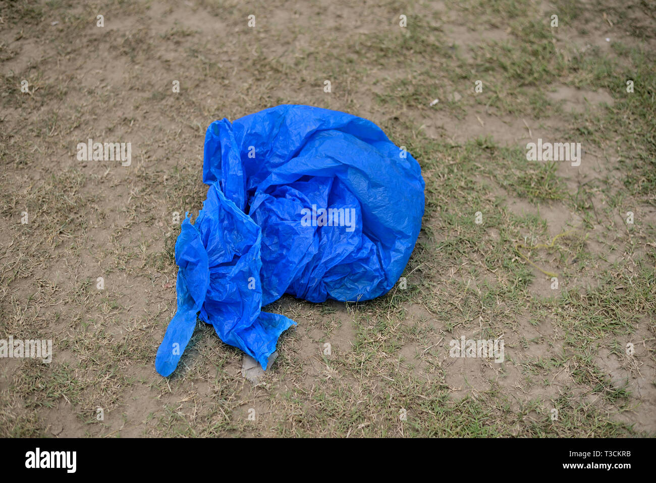 Waste Plastic packets are dumped on green grass field Stock Photo - Alamy
