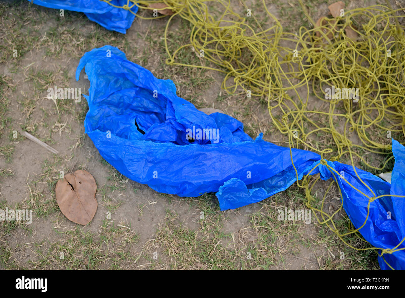 Waste Plastic packets are dumped on green grass field Stock Photo - Alamy