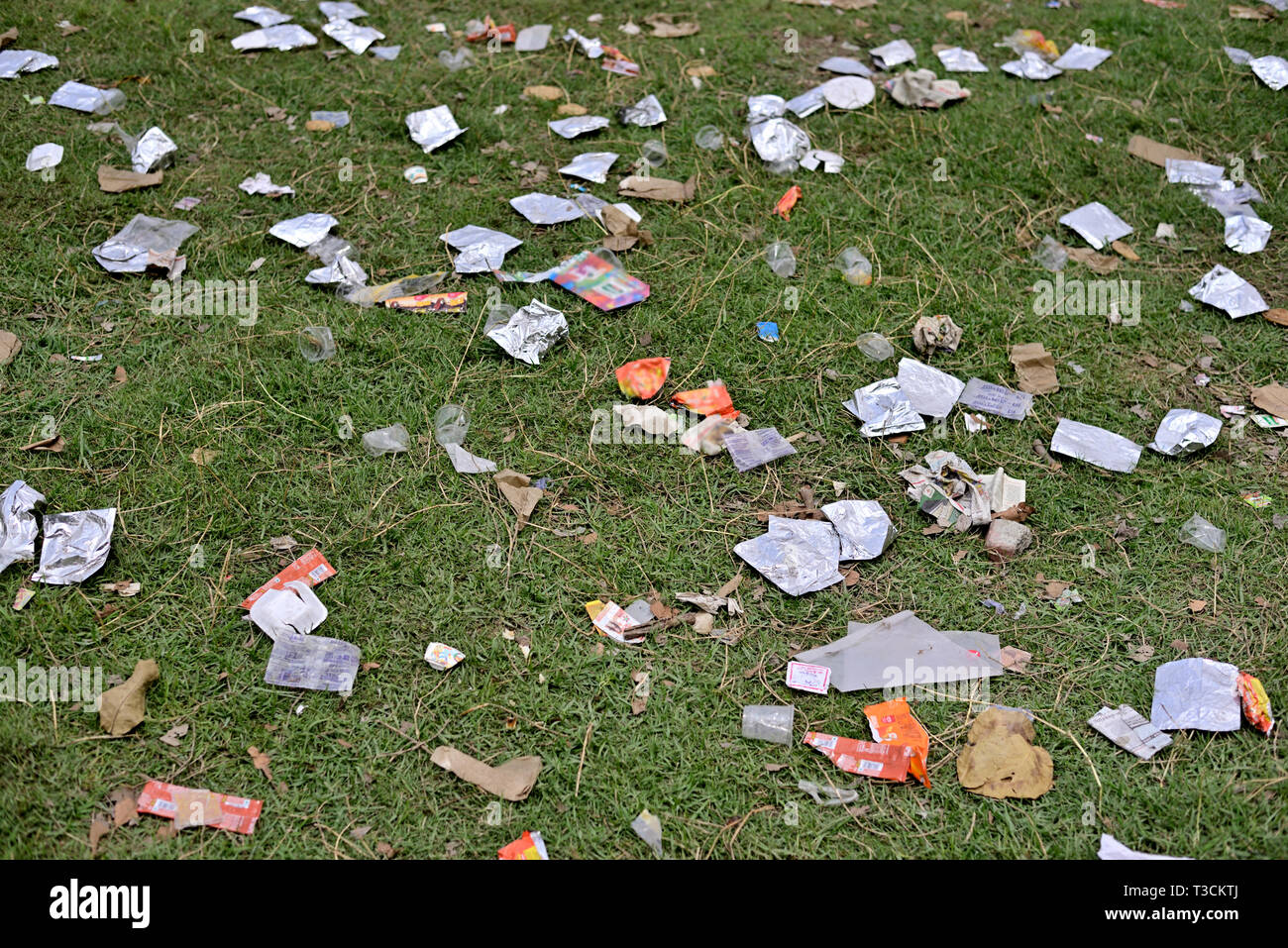 Waste Plastic packets are dumped on green grass field Stock Photo - Alamy