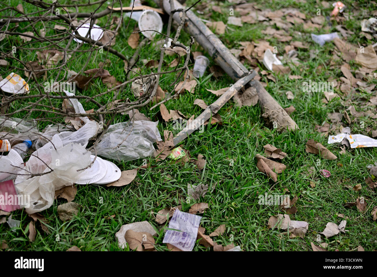 Waste Plastic packets are dumped on green field Stock Photo - Alamy