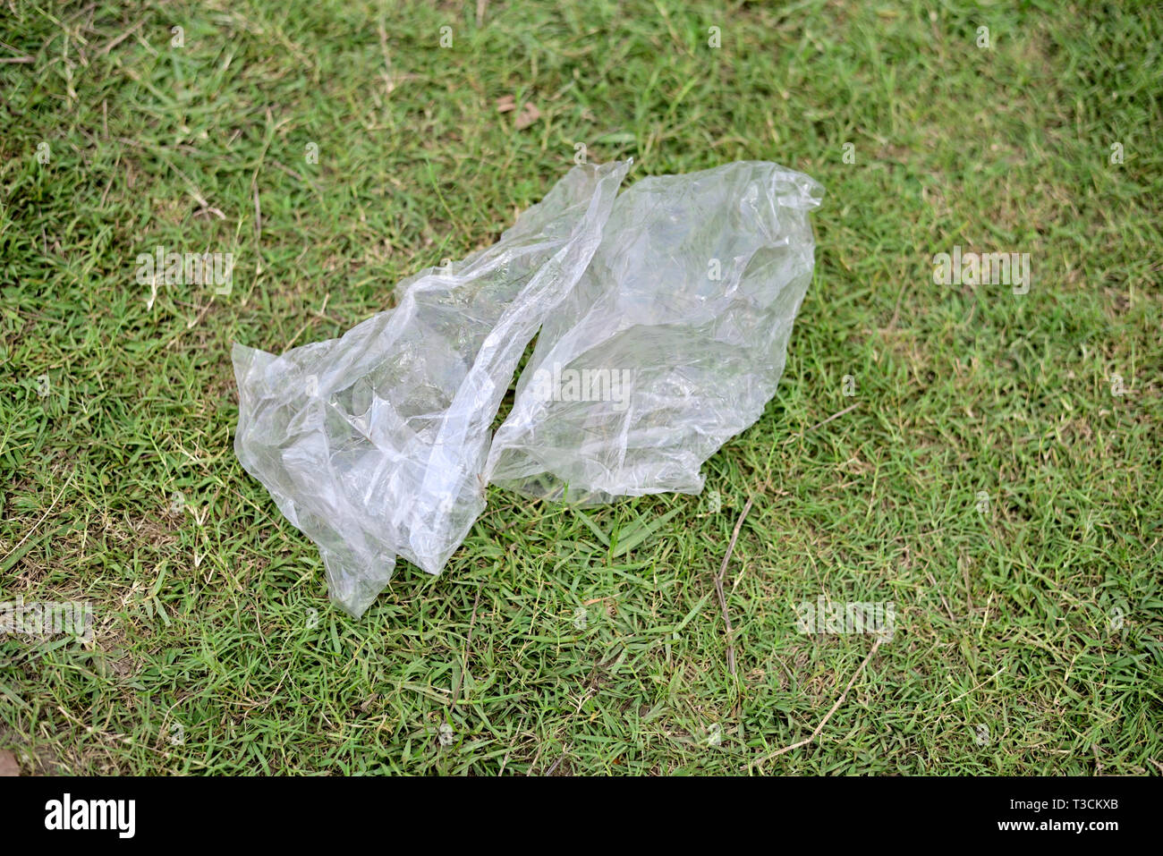 Waste Plastic packets are dumped on green grass field Stock Photo - Alamy