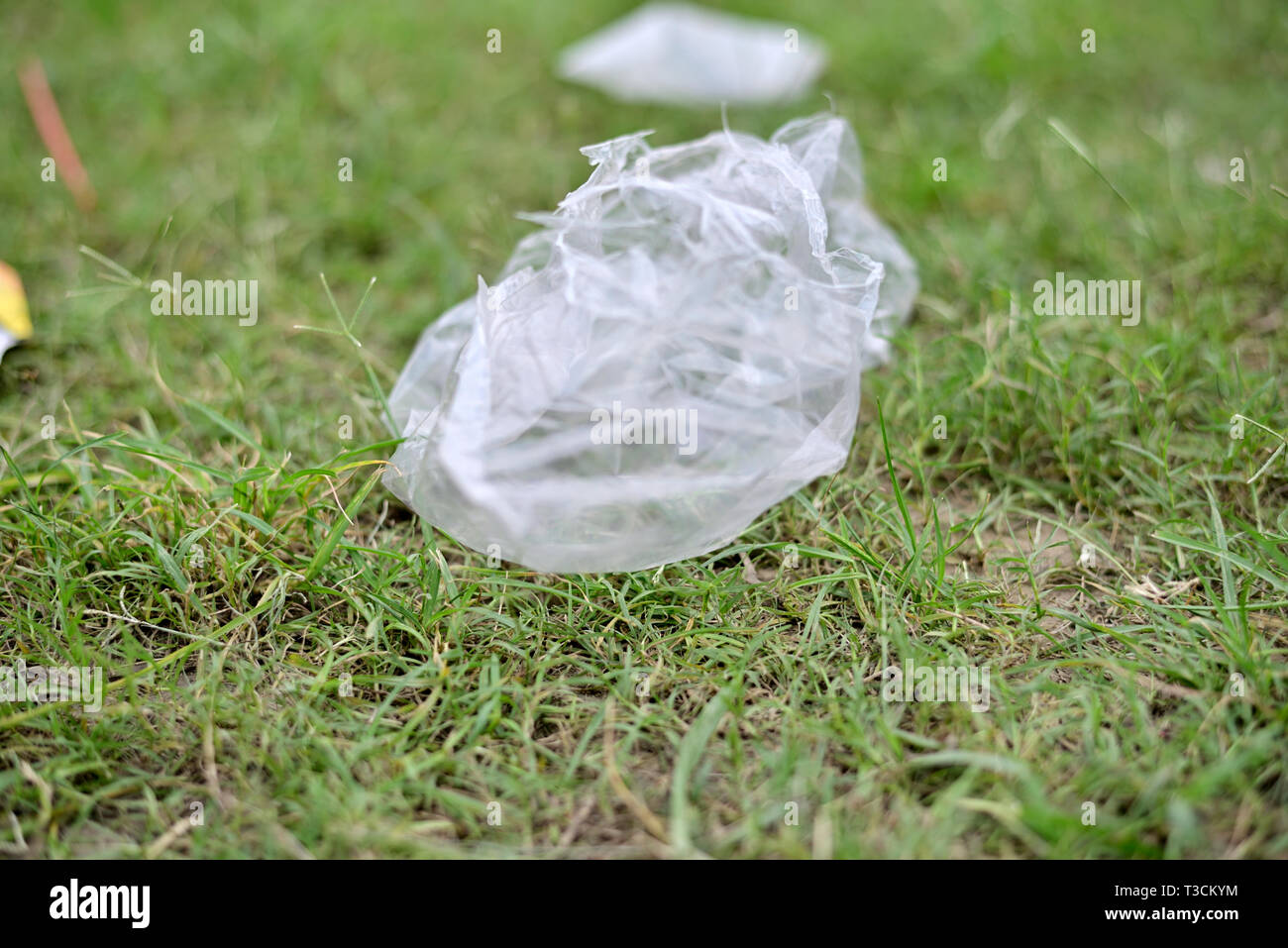 Waste Plastic packets are dumped on green grass field Stock Photo - Alamy
