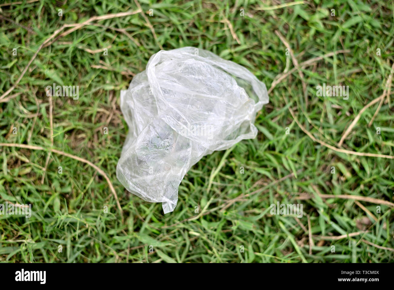 Waste Plastic packets are dumped on green grass field Stock Photo - Alamy