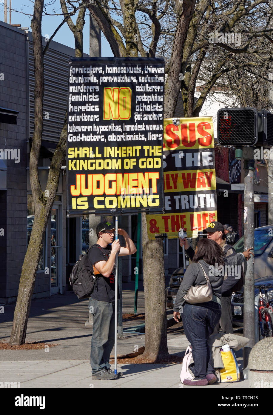 Christian religious fundamentalists carrying signs on a street corner ...