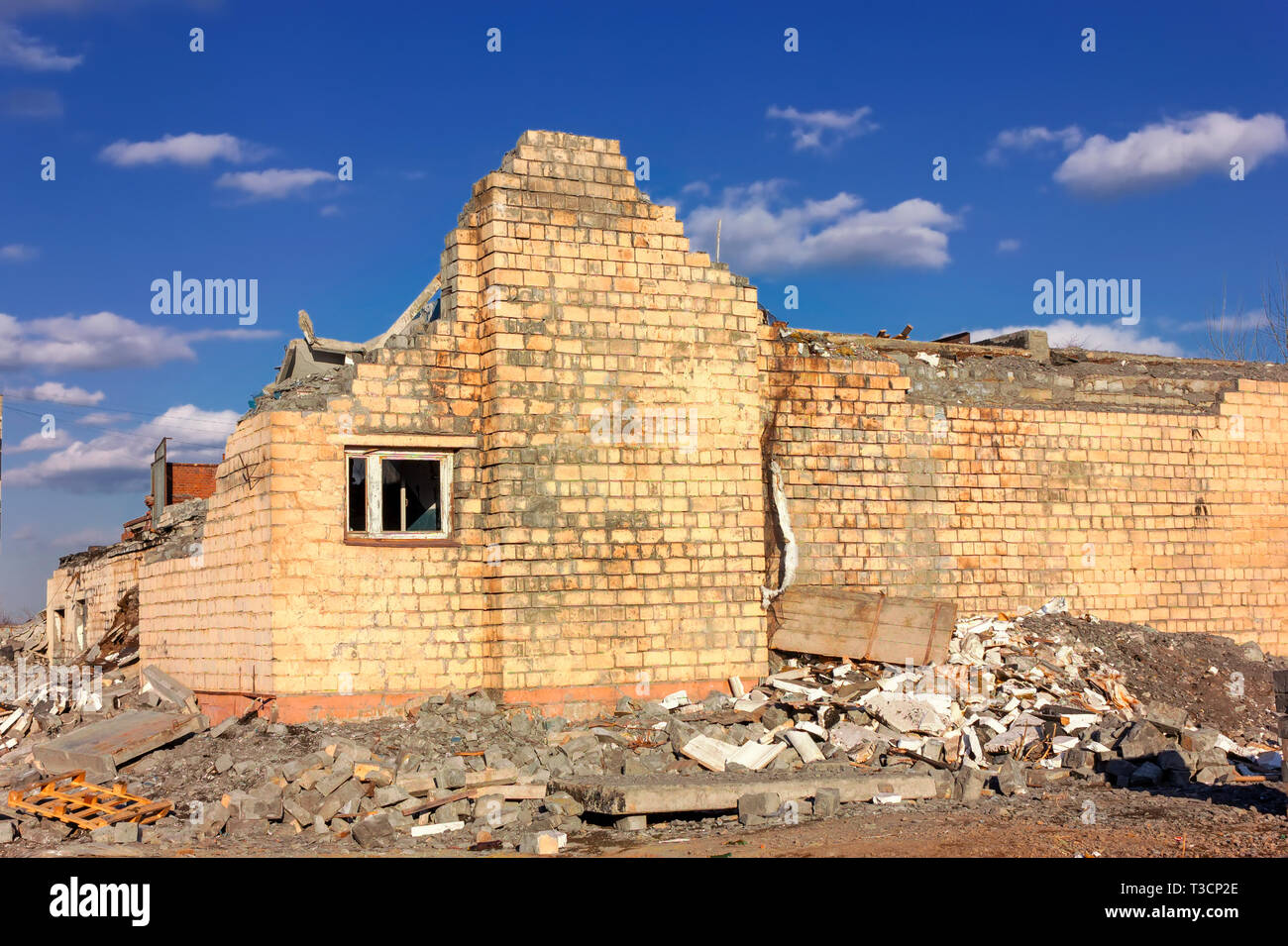 The ruins of a destroyed building in the city against the backdrop of a ...