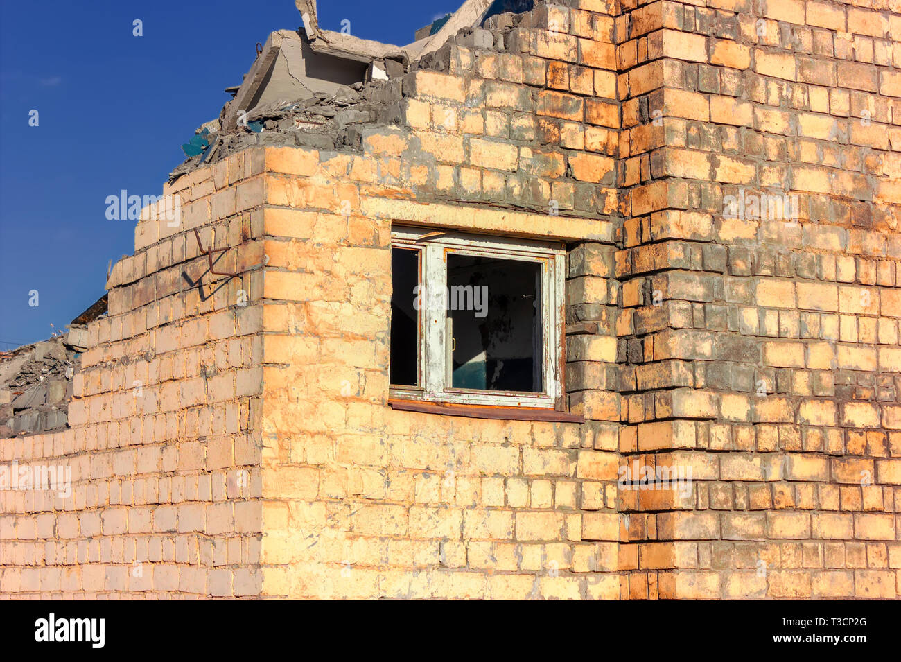 The ruins of a destroyed building in the city against the backdrop of a ...