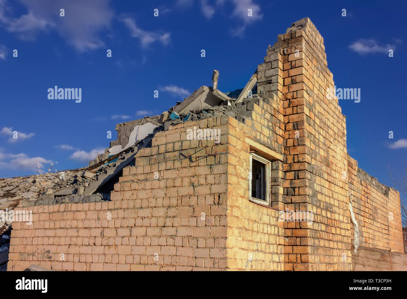 The ruins of a destroyed building in the city against the backdrop of a ...