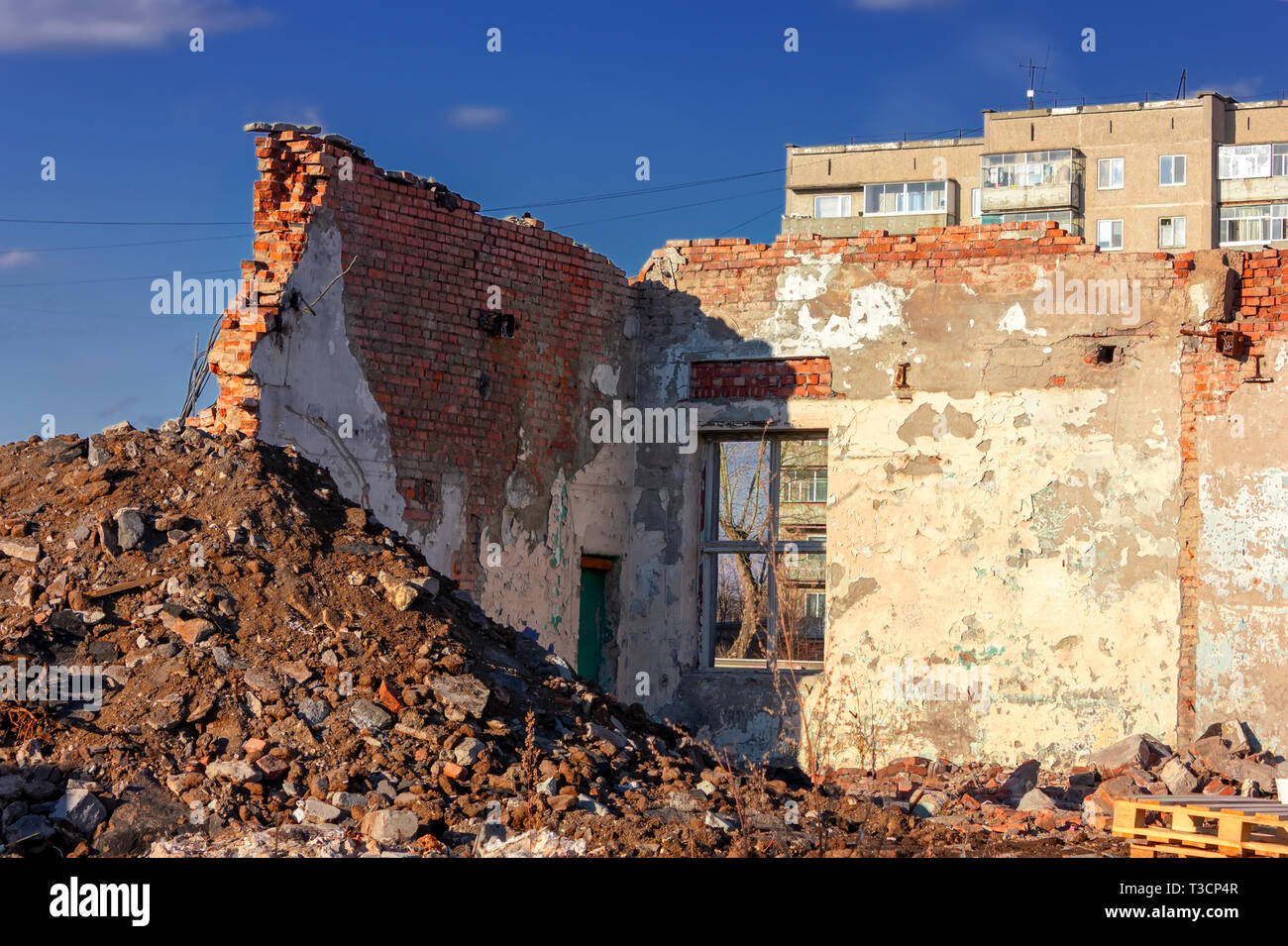 The ruins of a destroyed building in the city against the backdrop of a ...