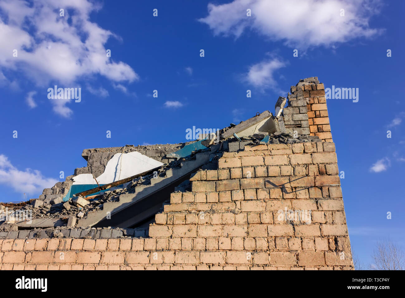 The ruins of a destroyed building in the city against the backdrop of a ...