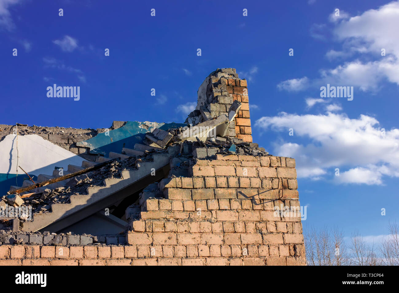 The ruins of a destroyed building in the city against the backdrop of a ...