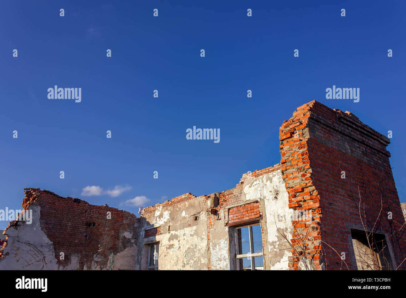 The ruins of a destroyed building in the city against the backdrop of a ...