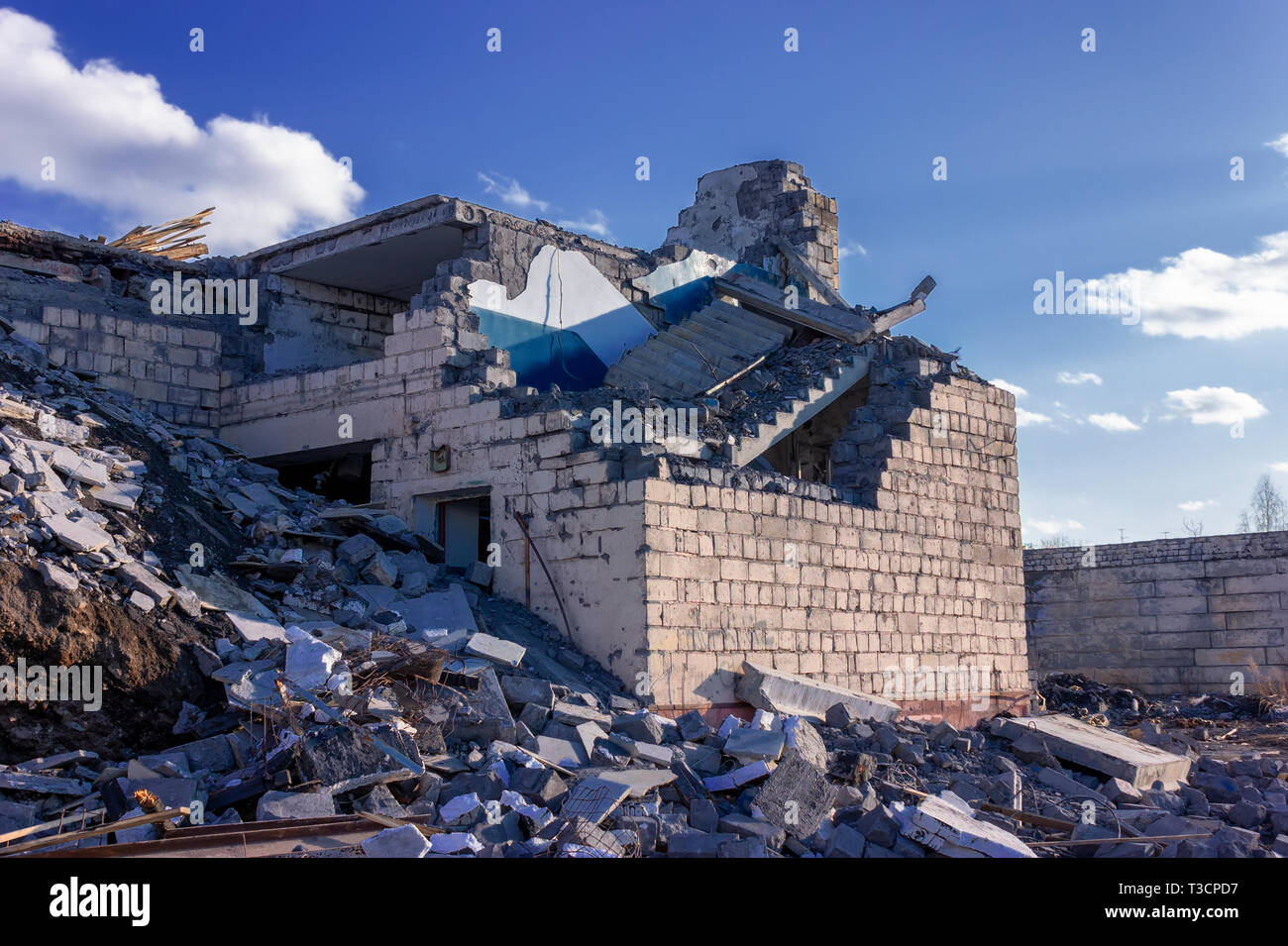 The ruins of a destroyed building in the city against the backdrop of a ...
