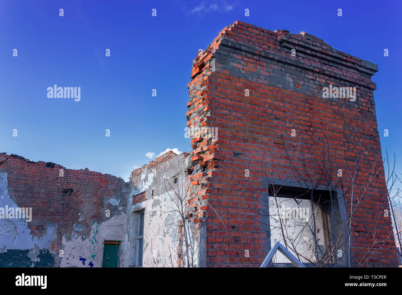 The ruins of a destroyed building in the city against the backdrop of a ...