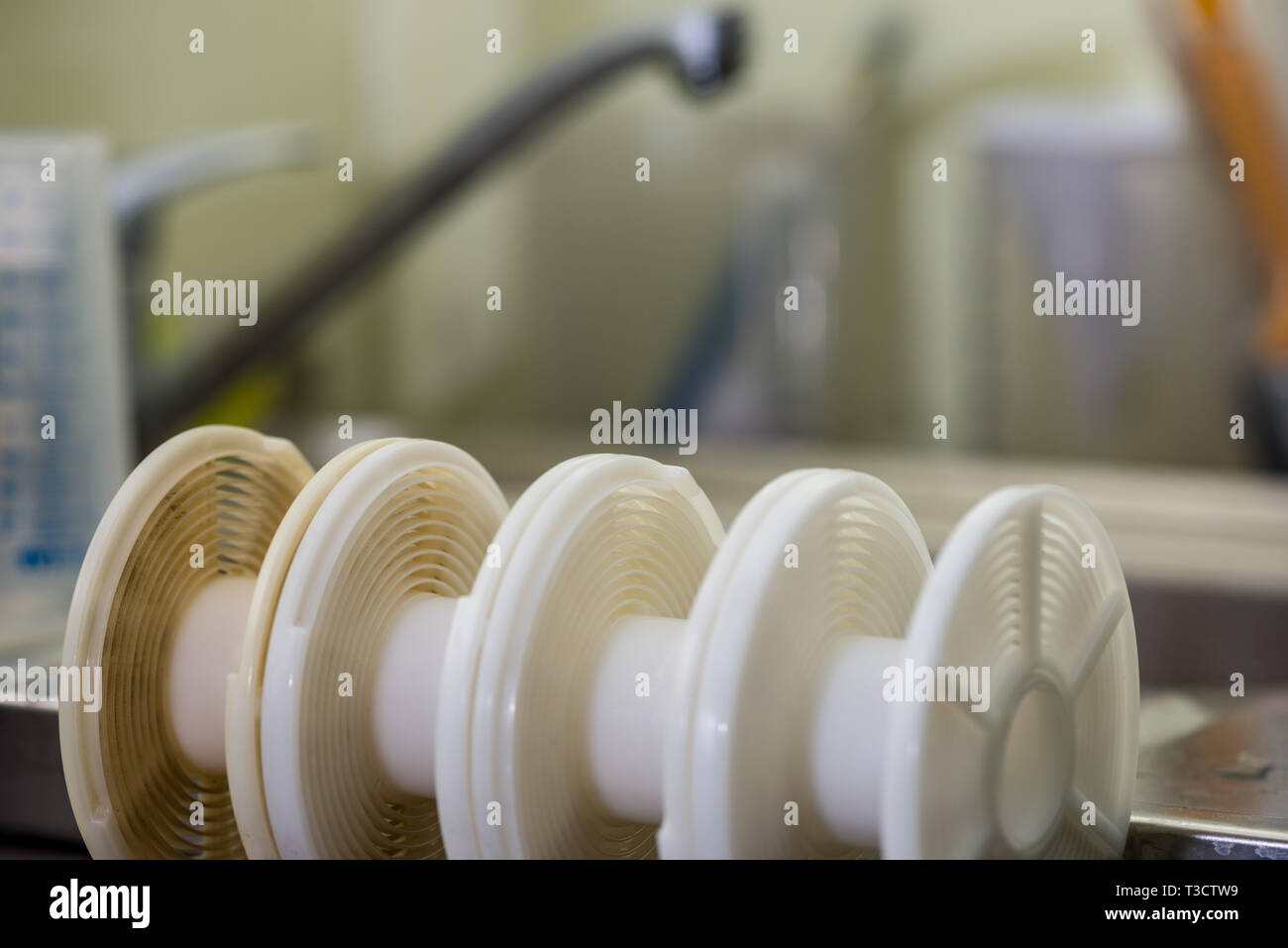 details of analog film laboratory equipment on the table. film rolls ...