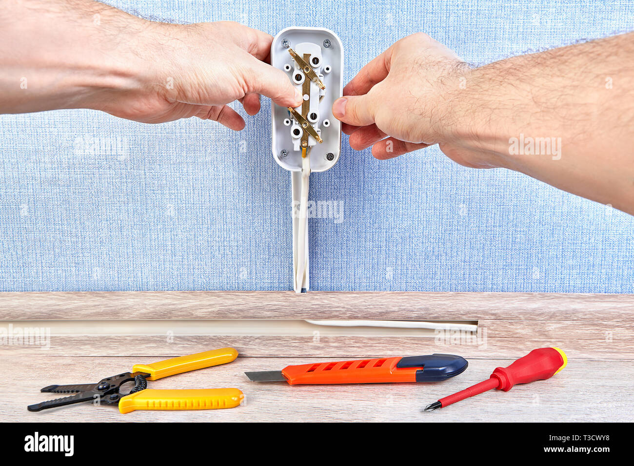 Installing euro wall plug socket by electrician, there are working ...