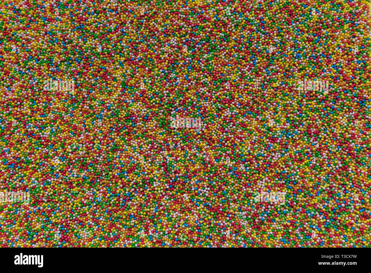 Colorful rainbow sprinkles decoration background. Sweets and sugar ...