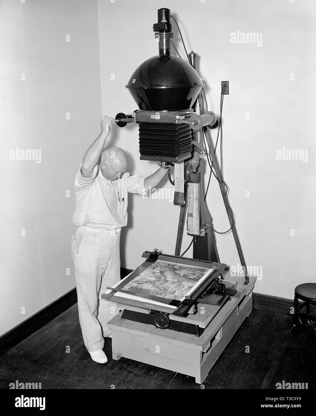 Map making - photographer making prints of a map ca. 1937 Stock Photo ...