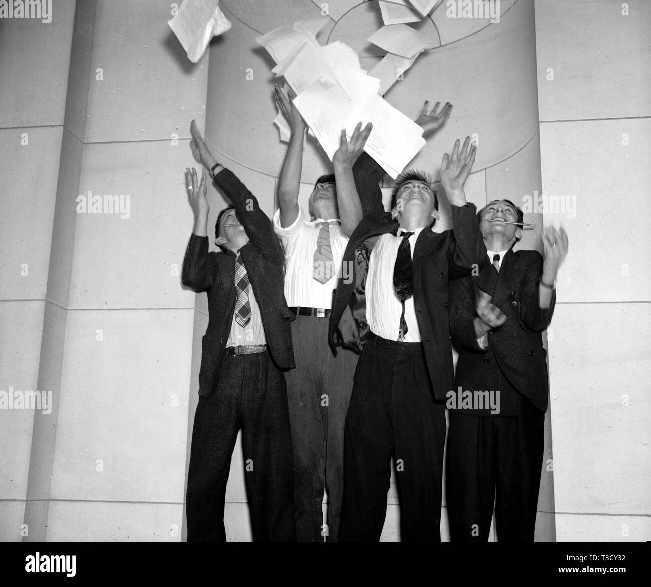 Young men throwing papers into the air ca. 1937 Stock Photo - Alamy