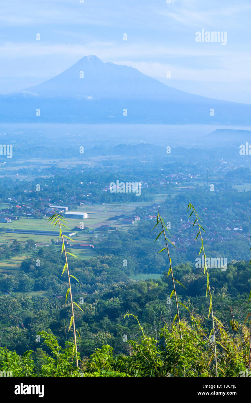 Yogyakarta basin and Merapi volcano looming in the distant. Merapi is a ...