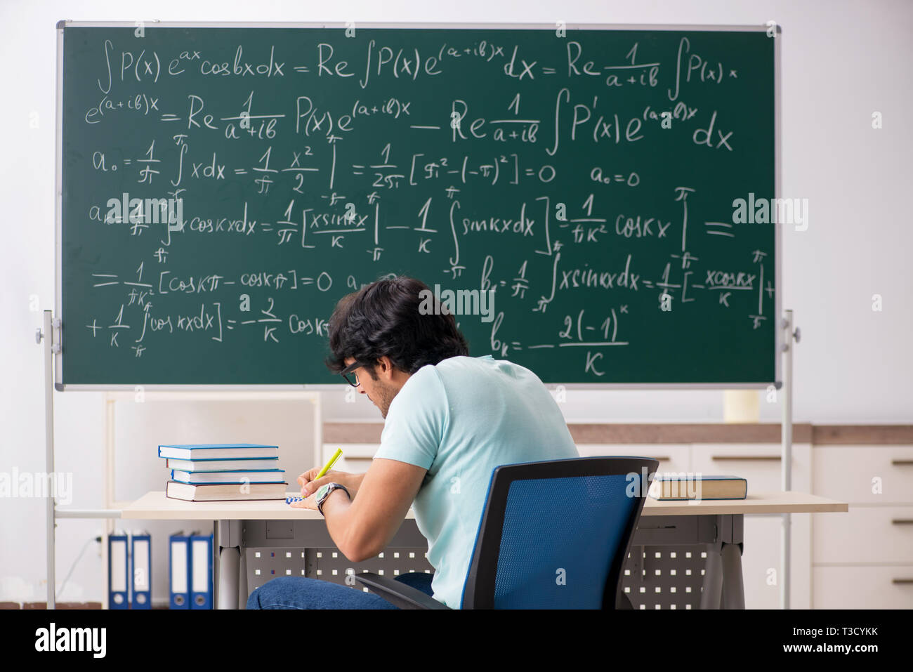 Young male student mathematician in front of chalkboard Stock Photo - Alamy